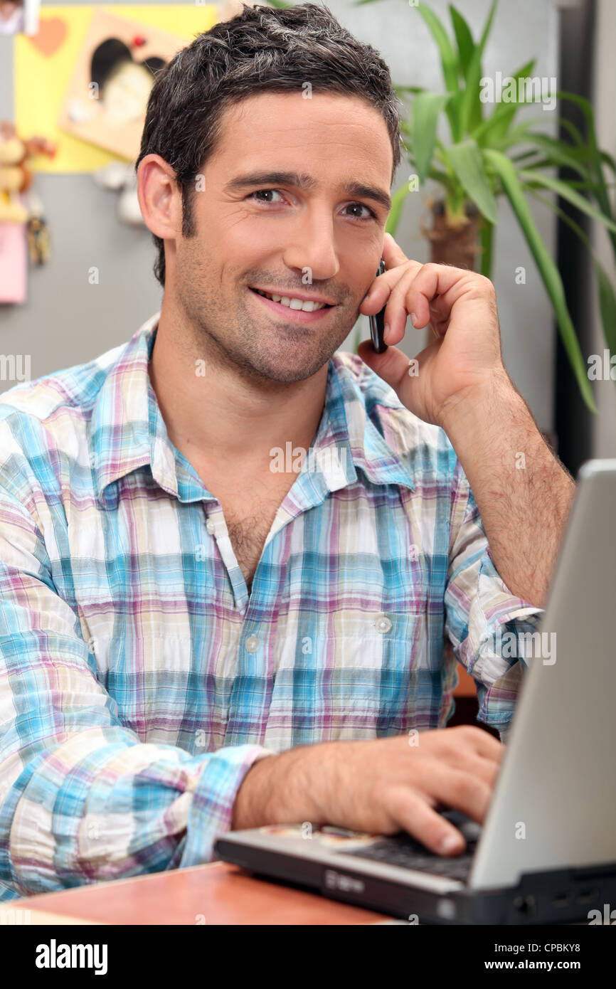 Man with computer at home Stock Photo - Alamy