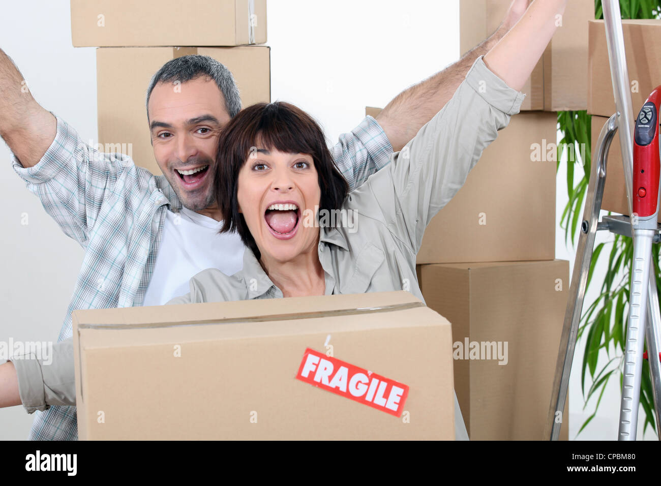 Couple celebrating moving in Stock Photo - Alamy