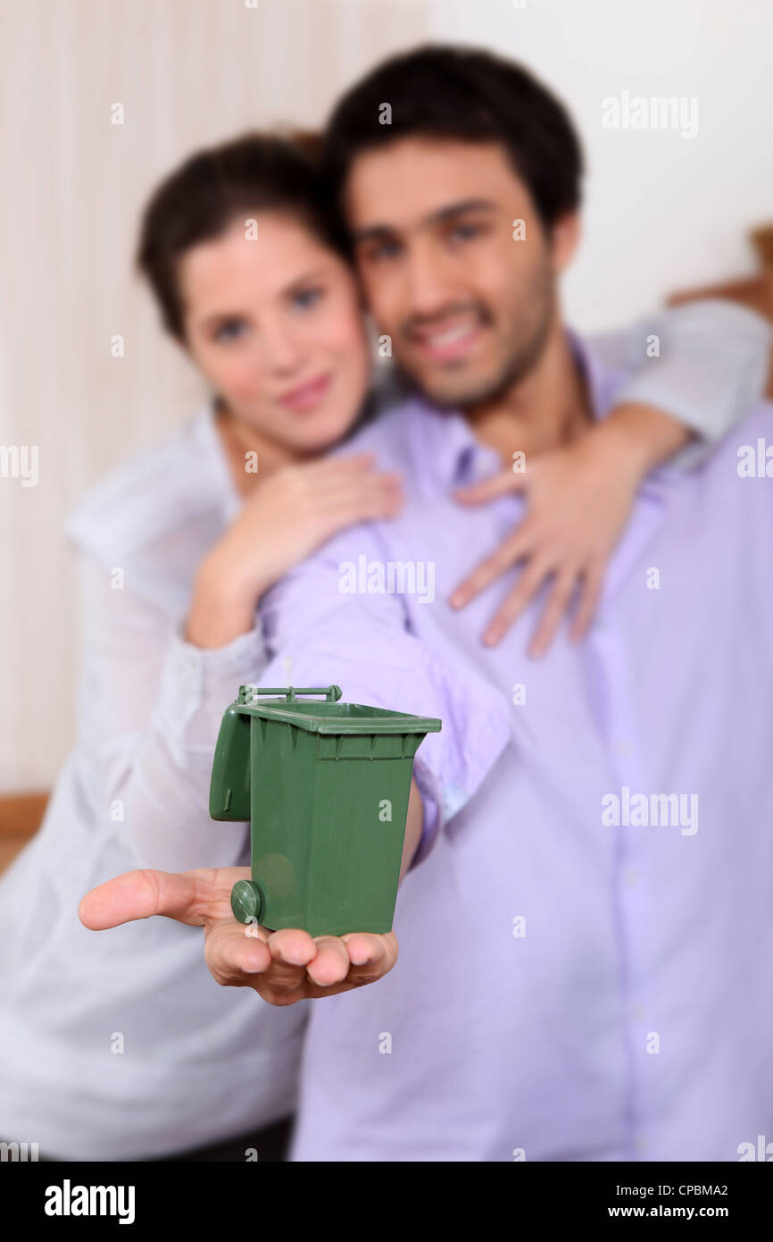 Couple holding miniature bin Stock Photo - Alamy