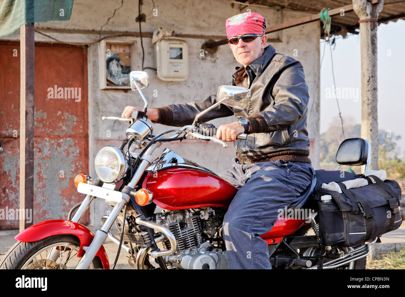 Western Rider touring in India at Roadside Shack sat on his red motor ...