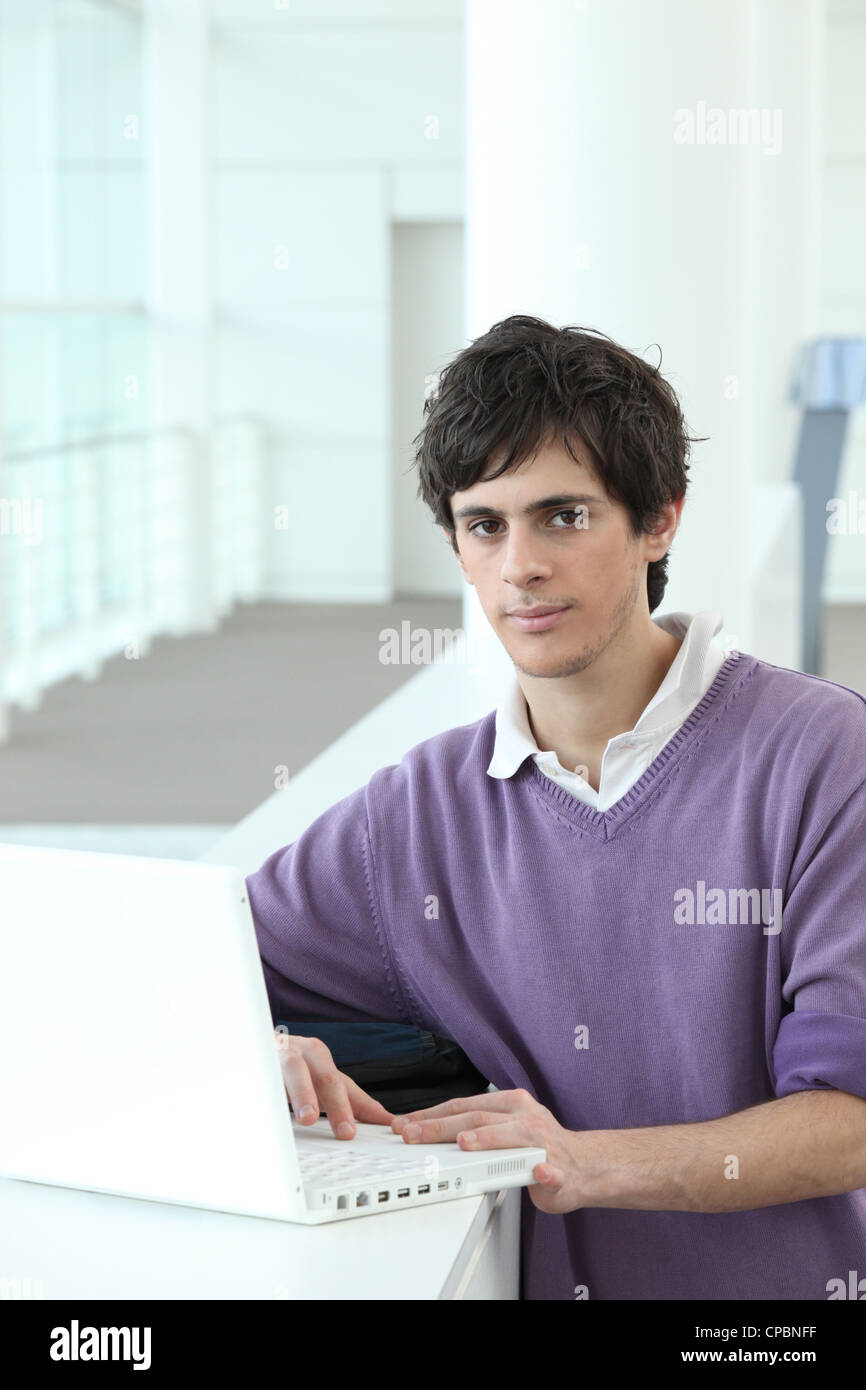 Young man using his computer at university Stock Photo - Alamy Young man using his computer at university Stock Photo - Alamy