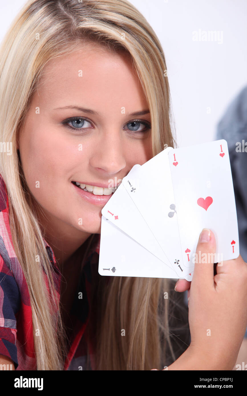 Teenage girl holding the winning card hand of four aces Stock Photo - Alamy