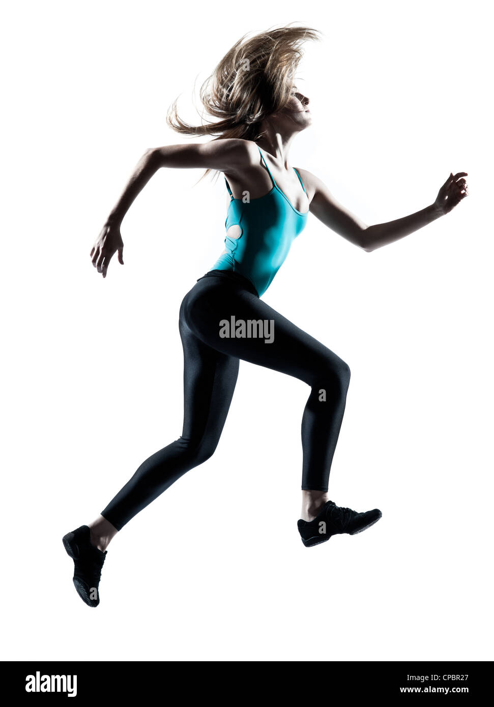 Side view of a beautiful fit and healthy blond woman running on white ...