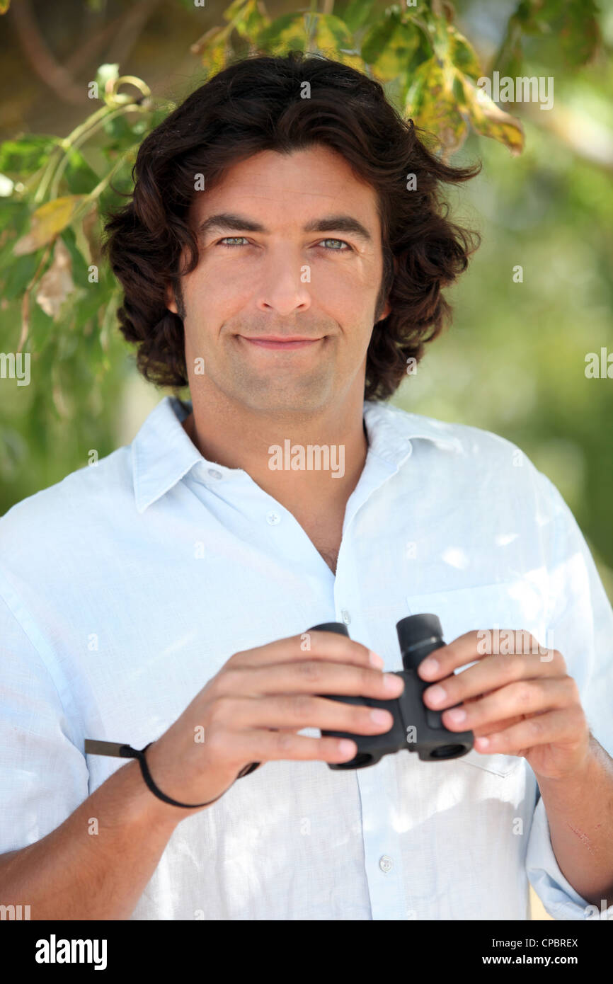 Man with binoculars Stock Photo - Alamy