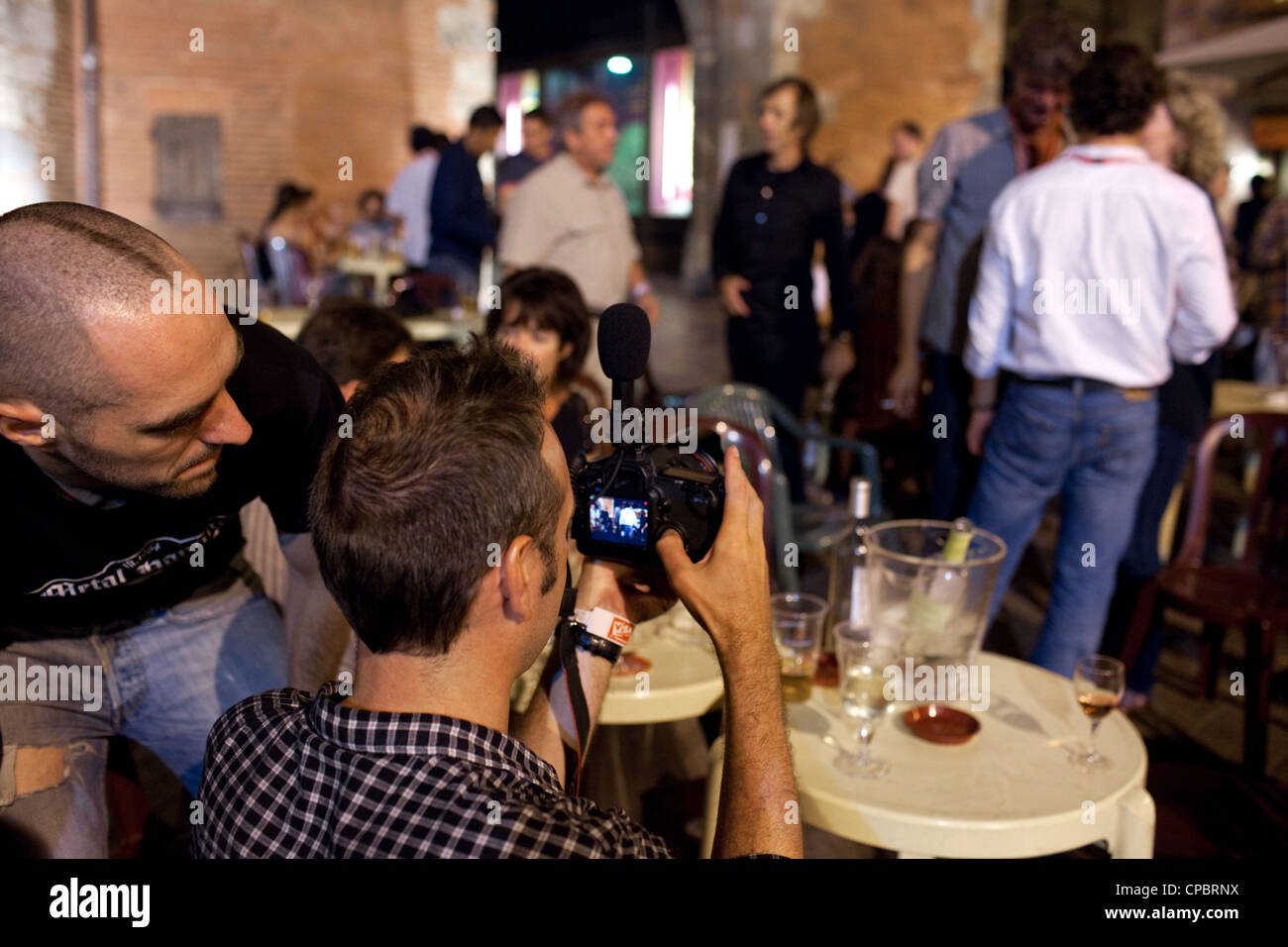 Peter Dench films at Cafe de la Poste during Visa Pour l'Image 2011 ...