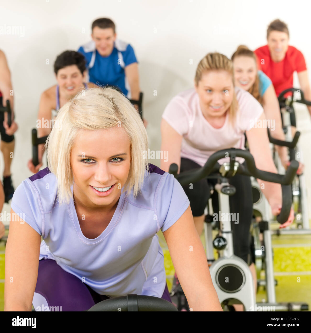 Fitness young woman on gym bike spinning indoor cardio exercise Stock ...