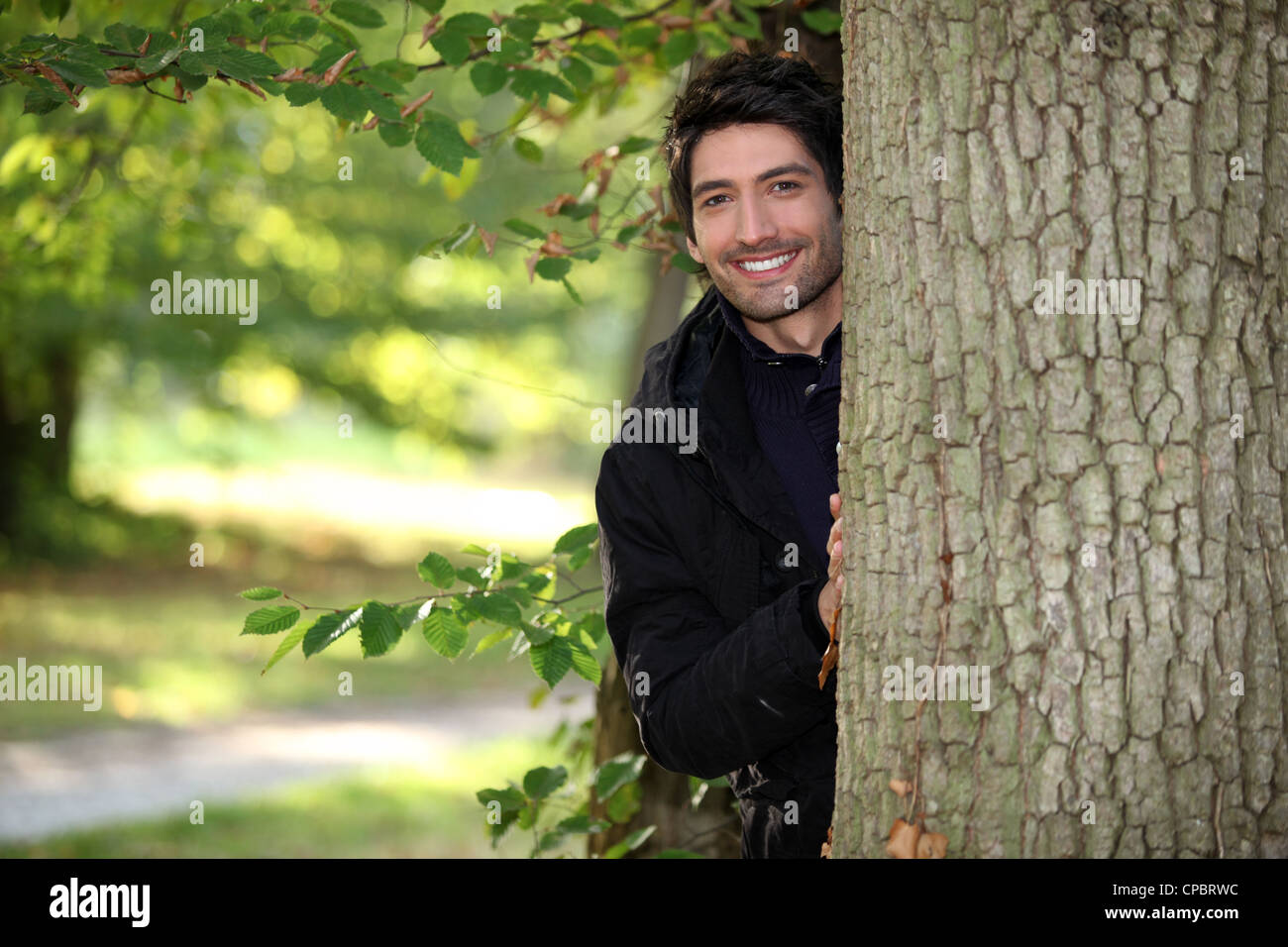 Hiding next to a tree hi-res stock photography and images - Alamy