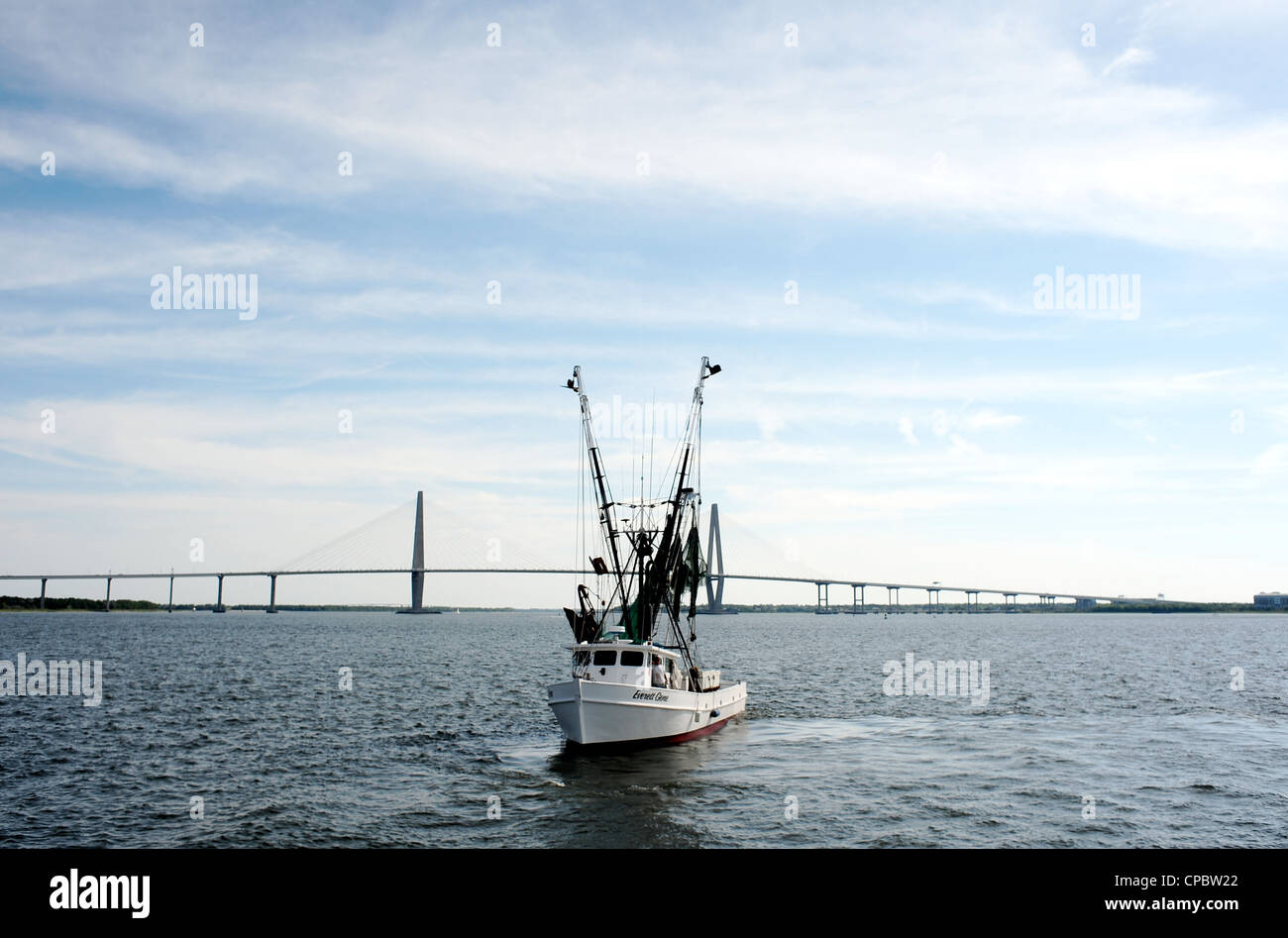 Trawler in Charleston, SC harbor with Ravenel bridge in background ...