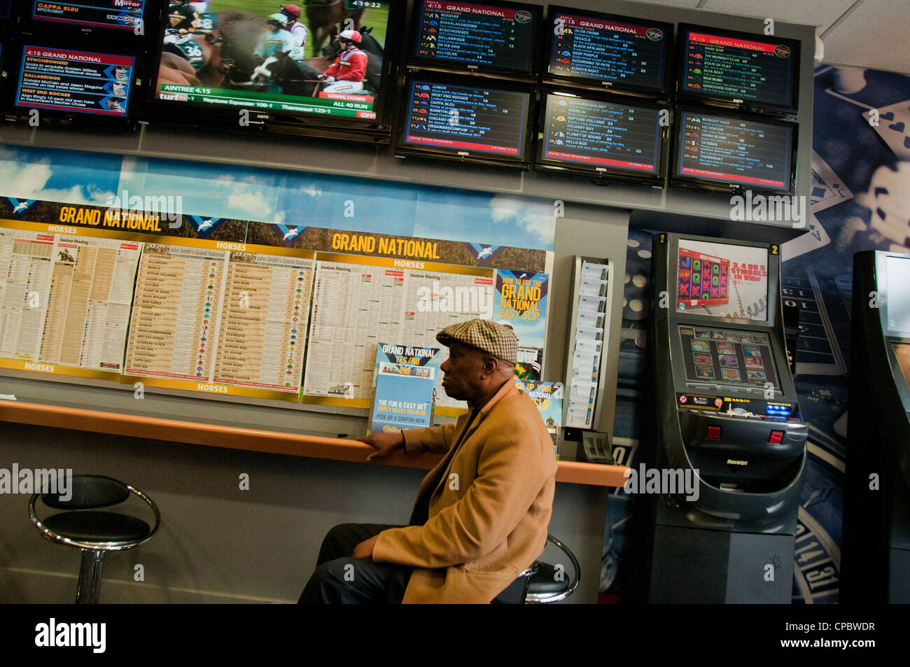 People in betting shop placing bets during grand national horse race ...