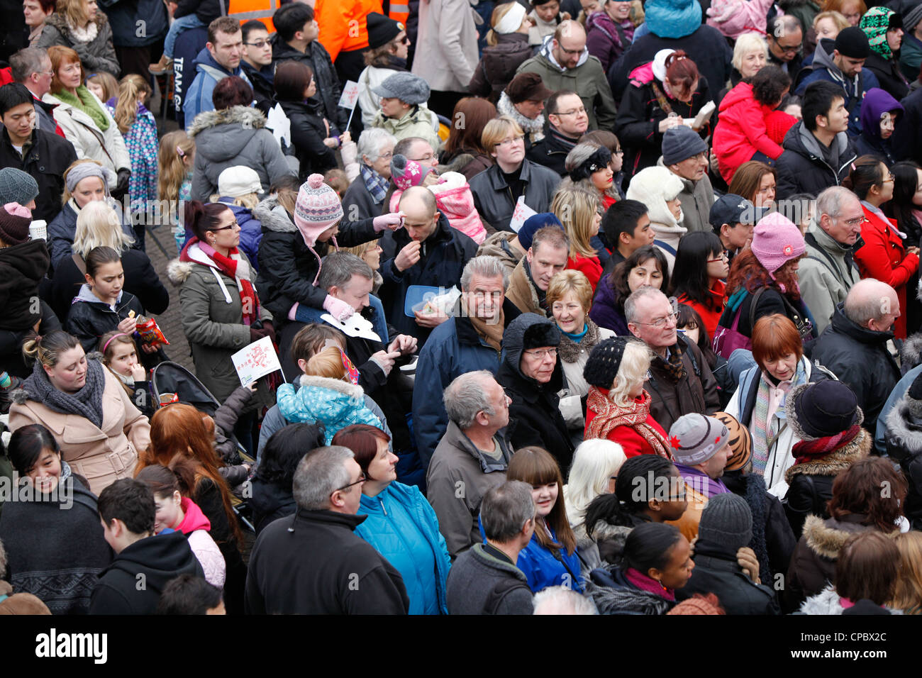 Crowds of people viewed from above gathered outdoors for an event Stock ...