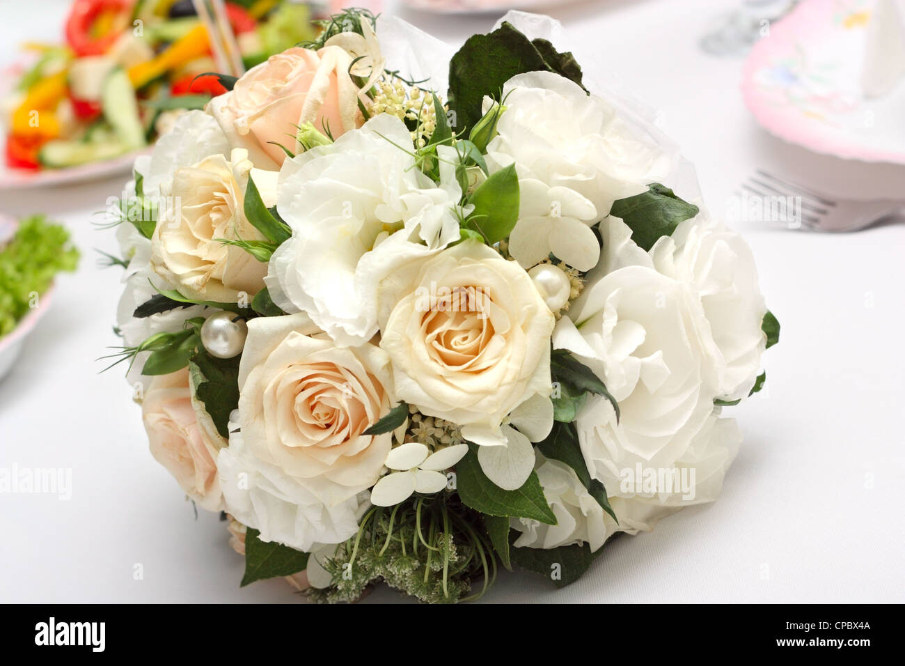 Wedding bouquet of white roses lying on the holiday table Stock Photo ...