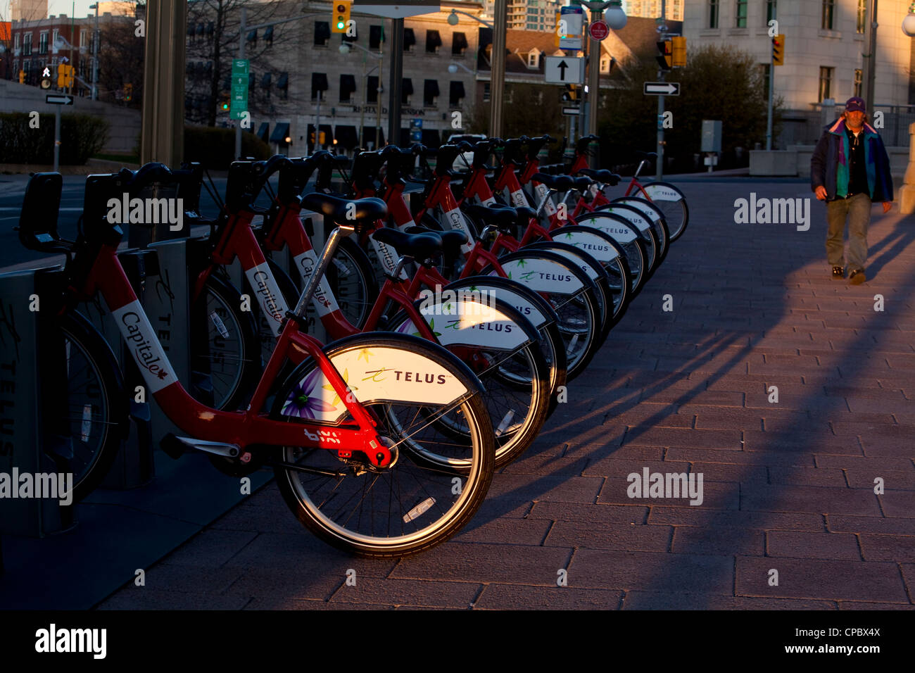 A man walks by a Capital Bixi station in Ottawa Stock Photo - Alamy