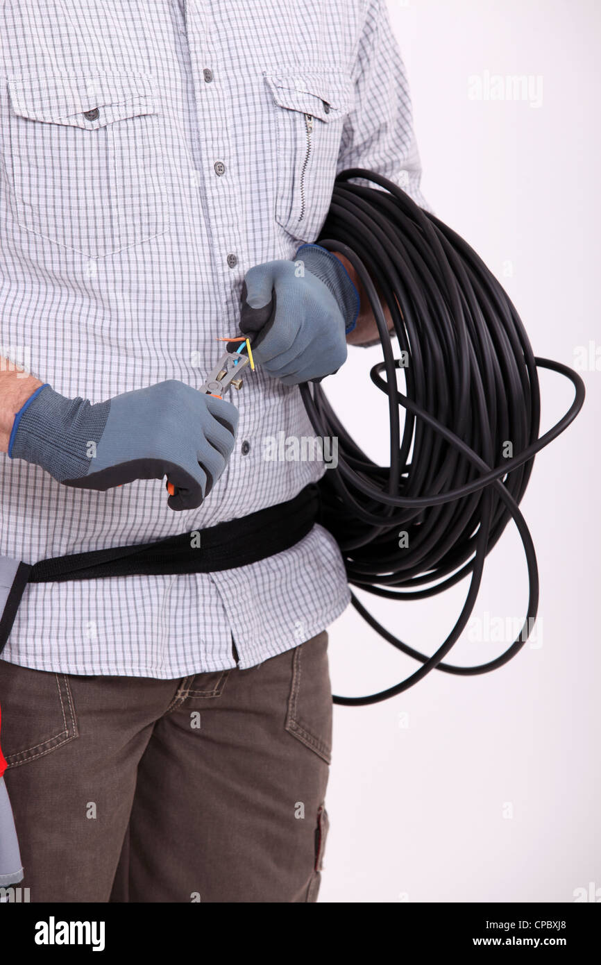 Man preparing length of wire Stock Photo - Alamy