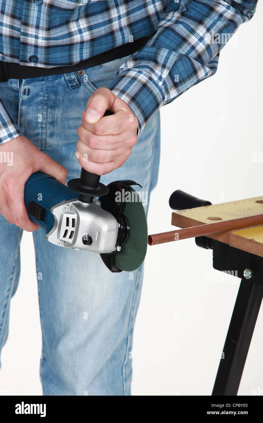 Man holding a grinding machine Stock Photo - Alamy