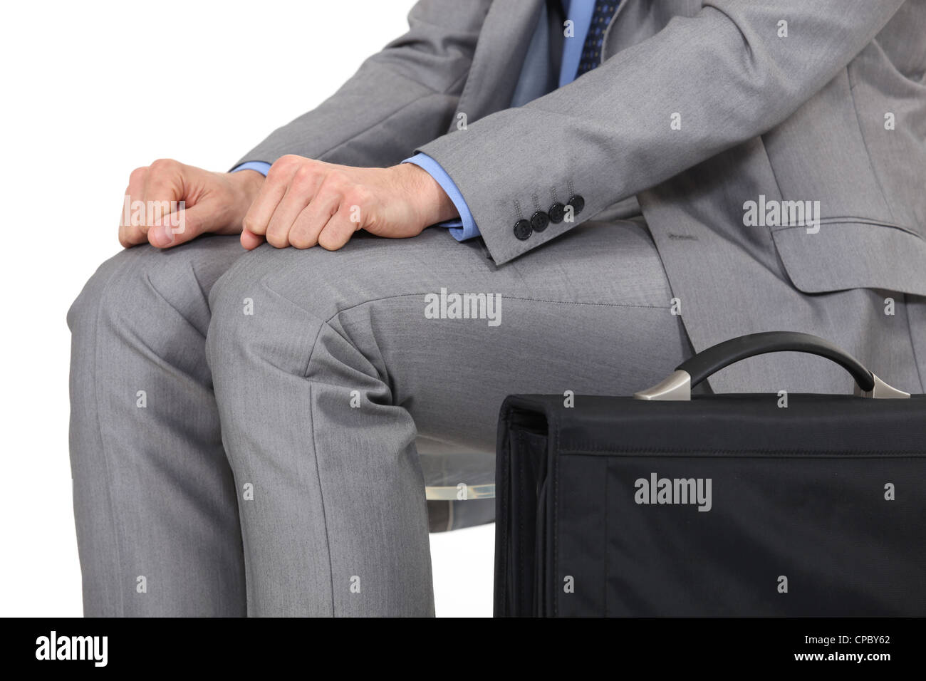 man in a suit sitting and waiting Stock Photo - Alamy