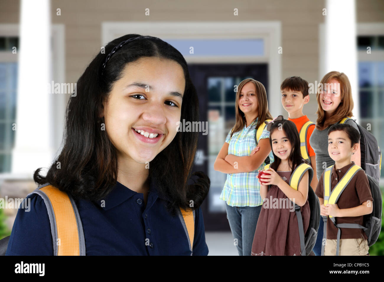 Group of children standing in front of their school Stock Photo - Alamy