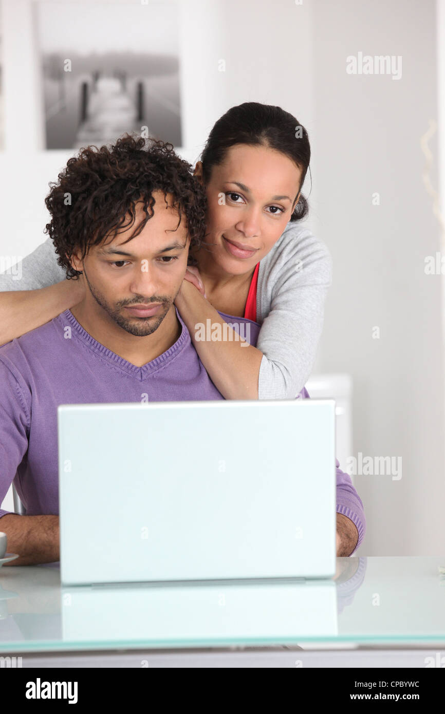 Couple at home with a laptop computer Stock Photo - Alamy