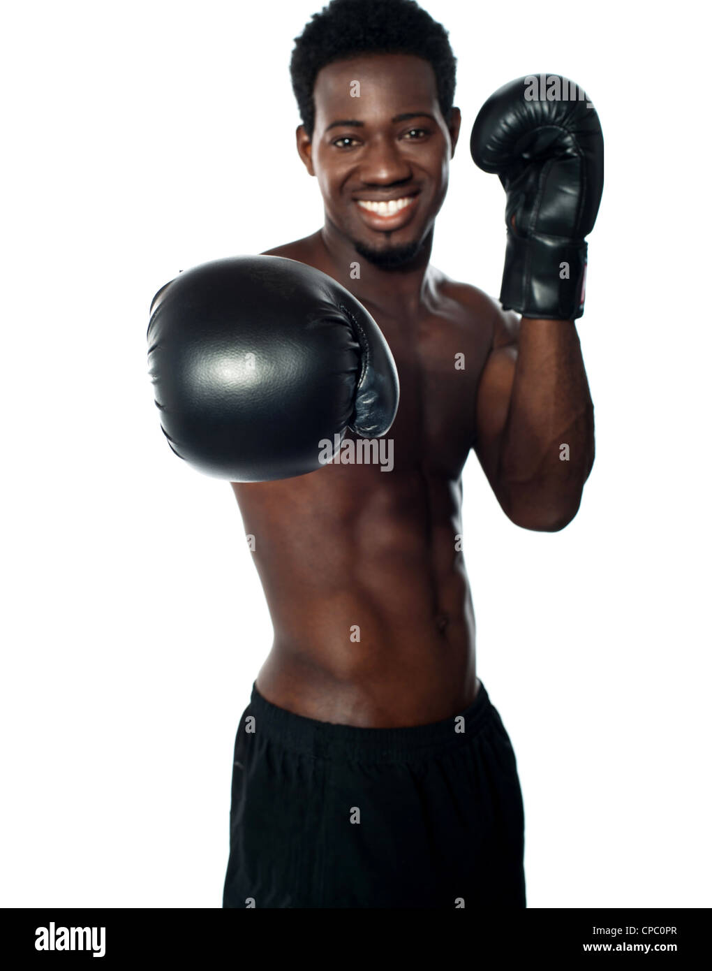 Shirtless african boxer throwing a punch at the camera Stock Photo - Alamy