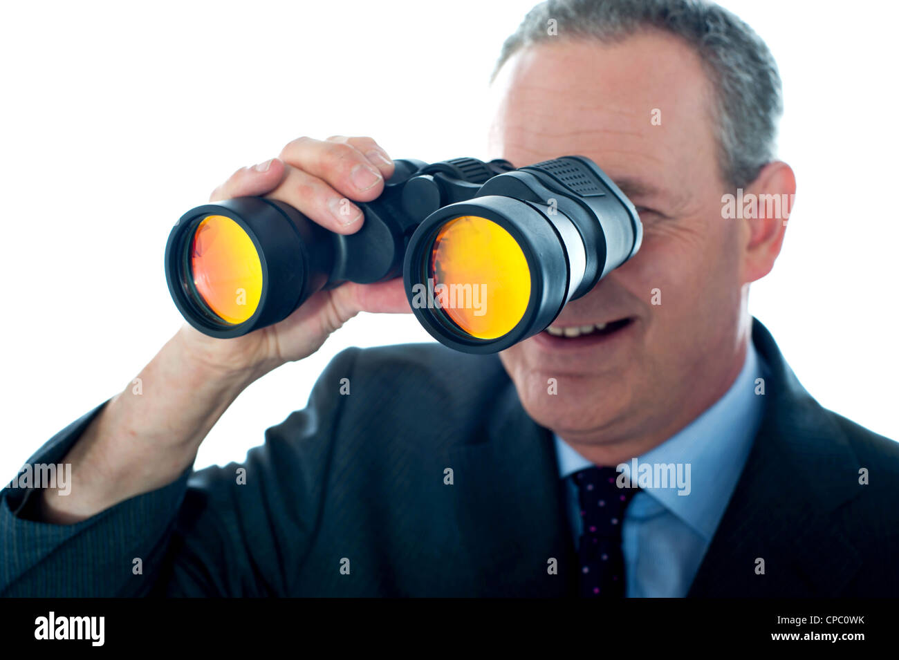 Senior man observing through binoculars isolated over white background ...