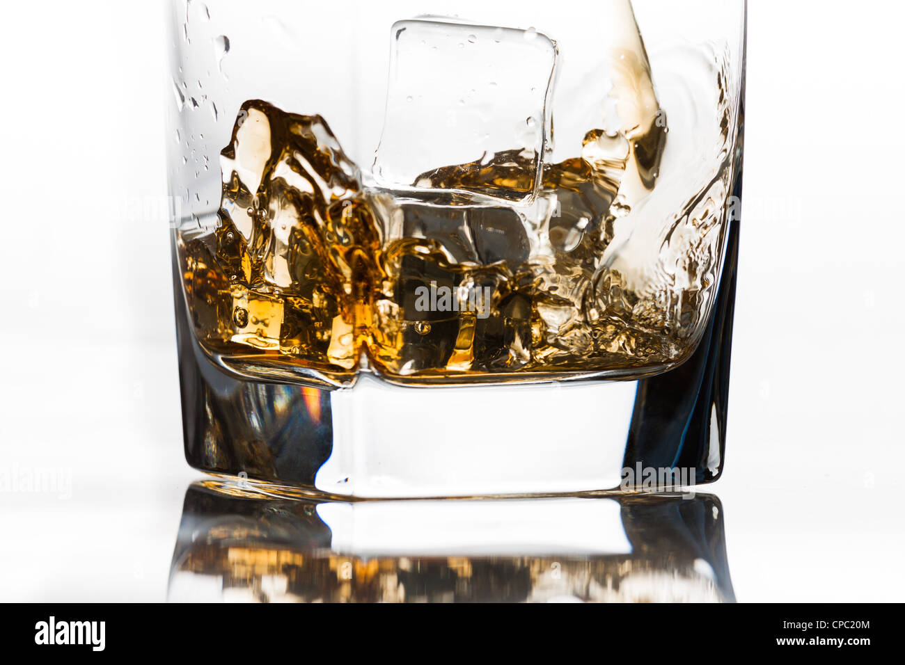 Splash of whiskey on the rocks Stock Photo - Alamy