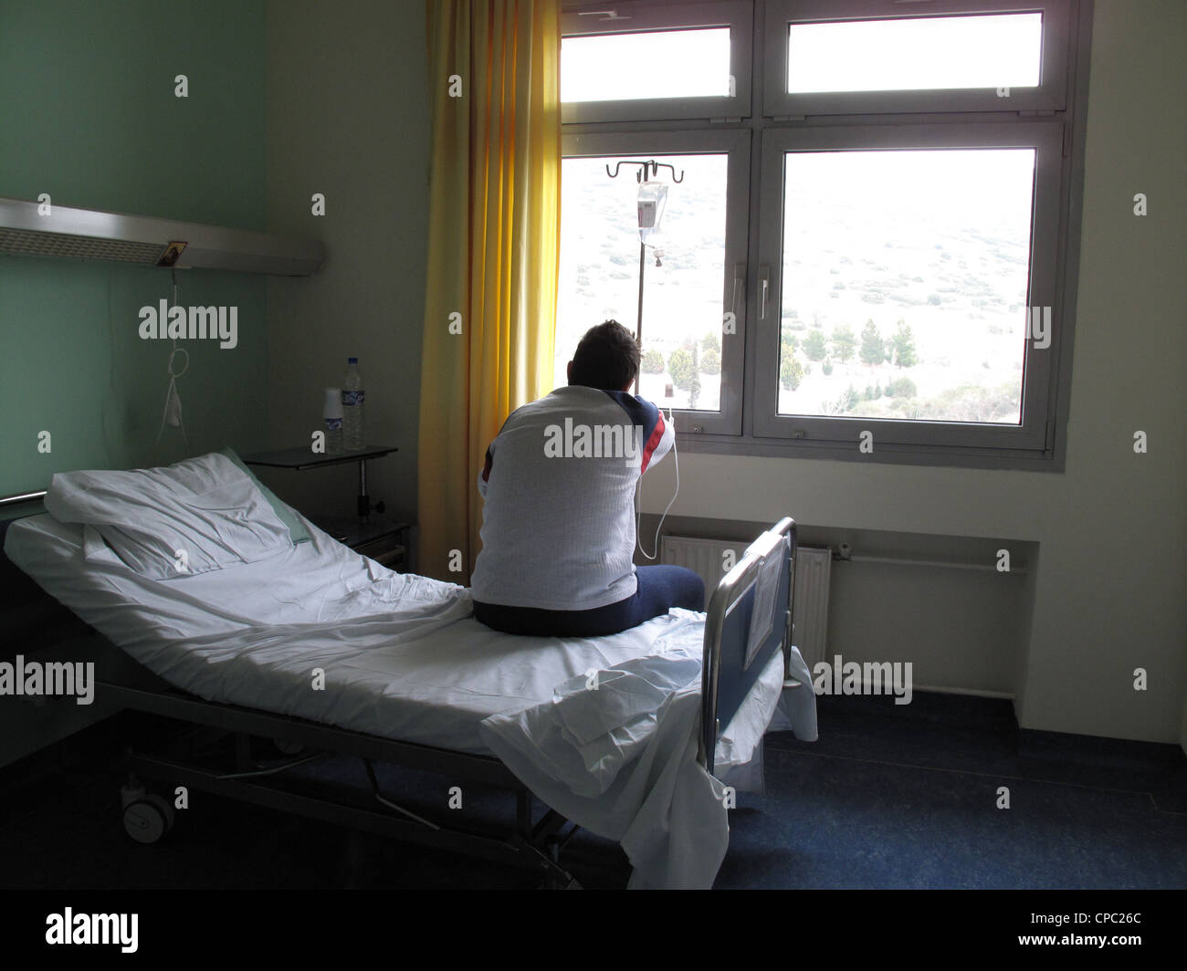 Hospital patient looking out window Stock Photo - Alamy