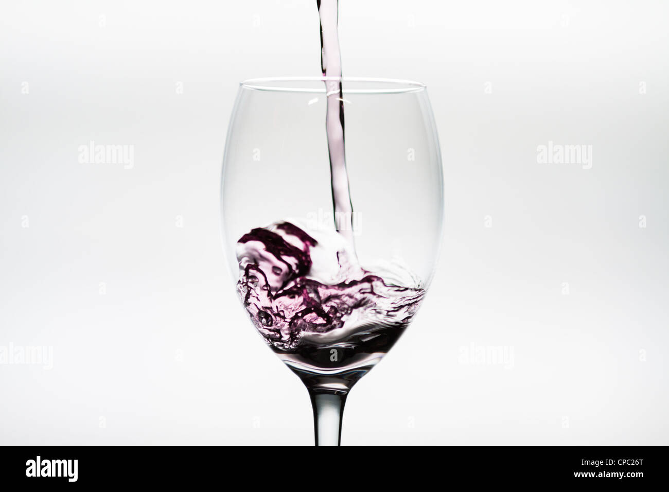Splash of wine inside a wineglass Stock Photo - Alamy