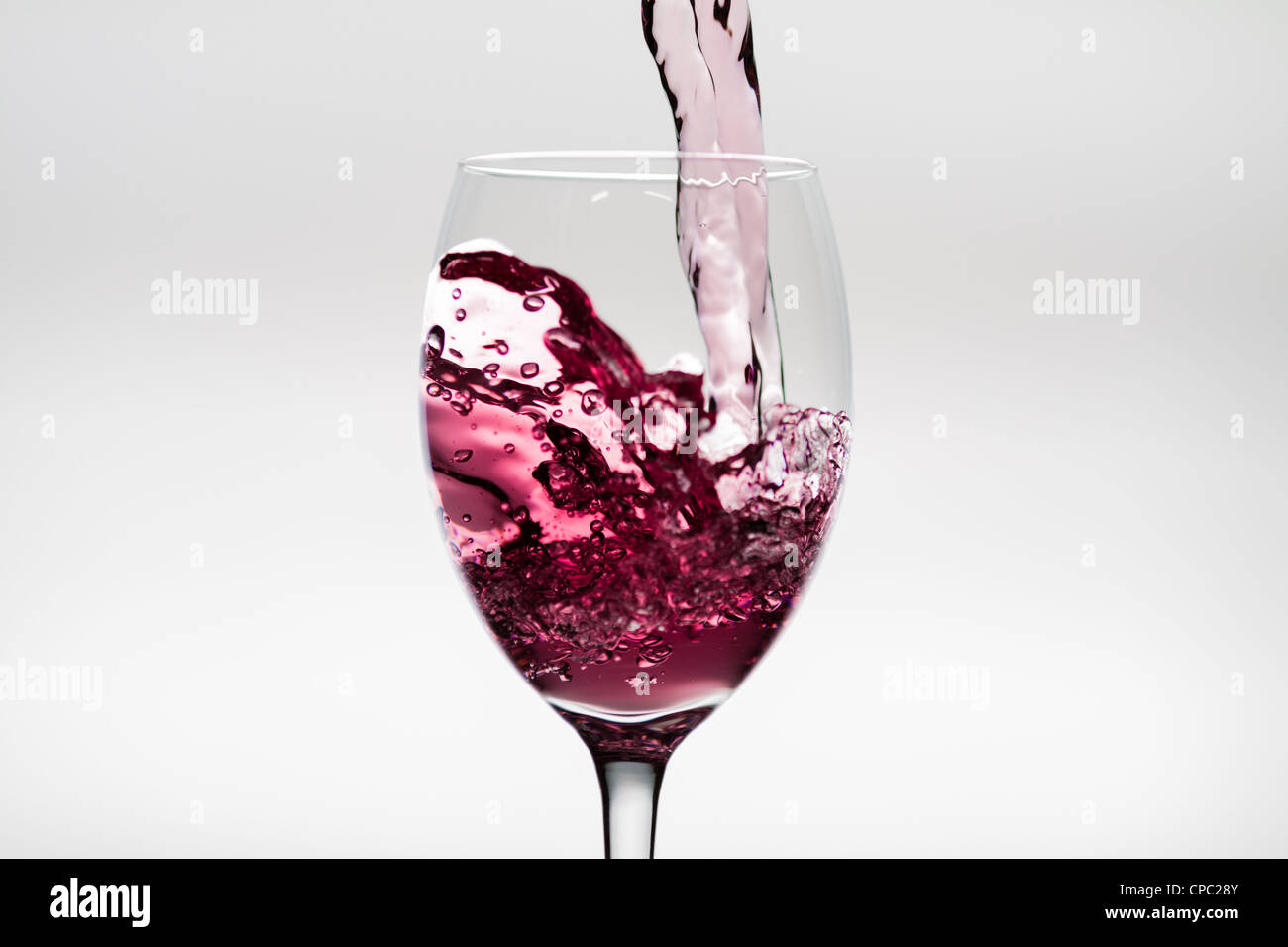 Flush of wine falling into a wineglass Stock Photo - Alamy