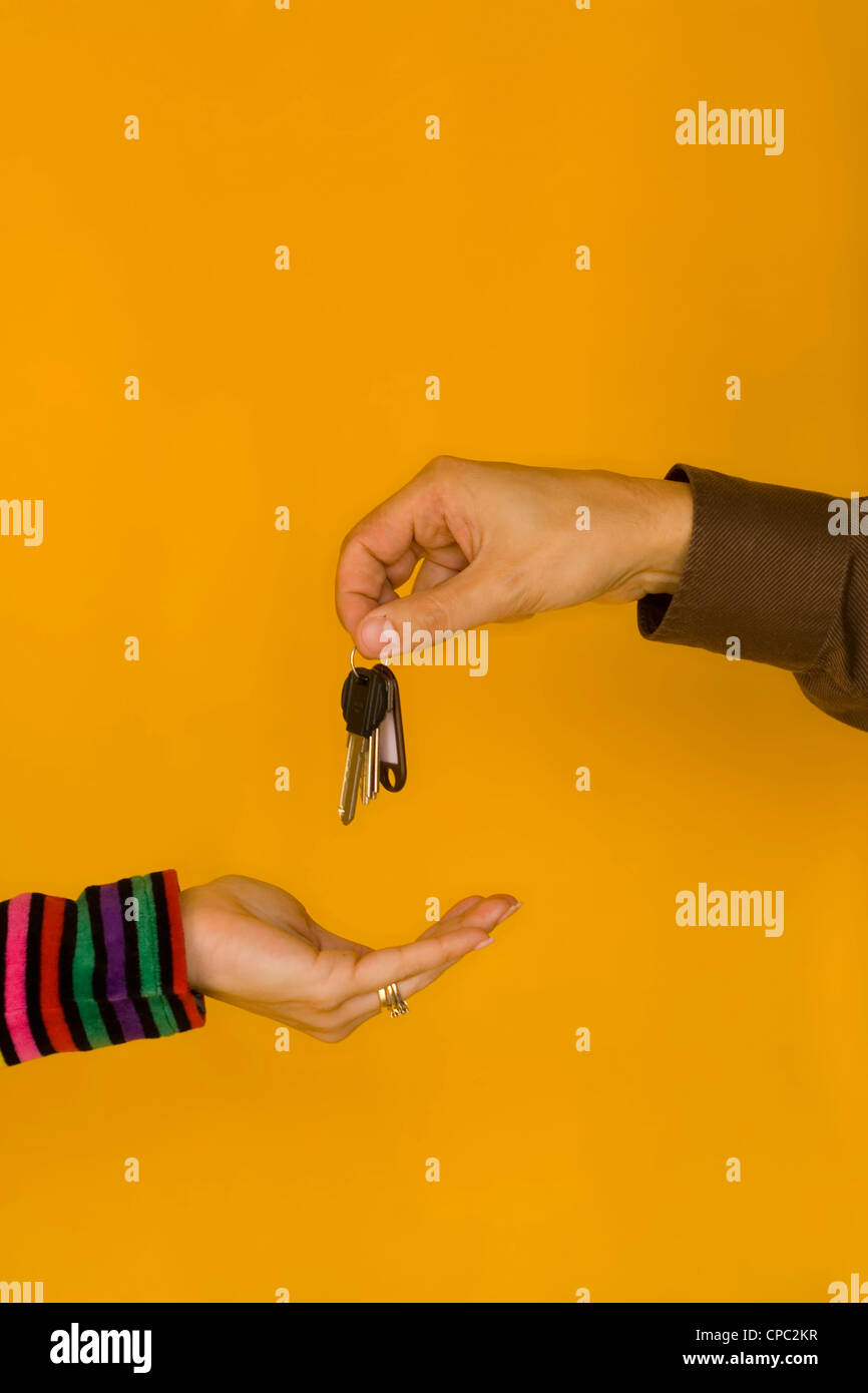 a business man passing the keys to a young woman Stock Photo - Alamy