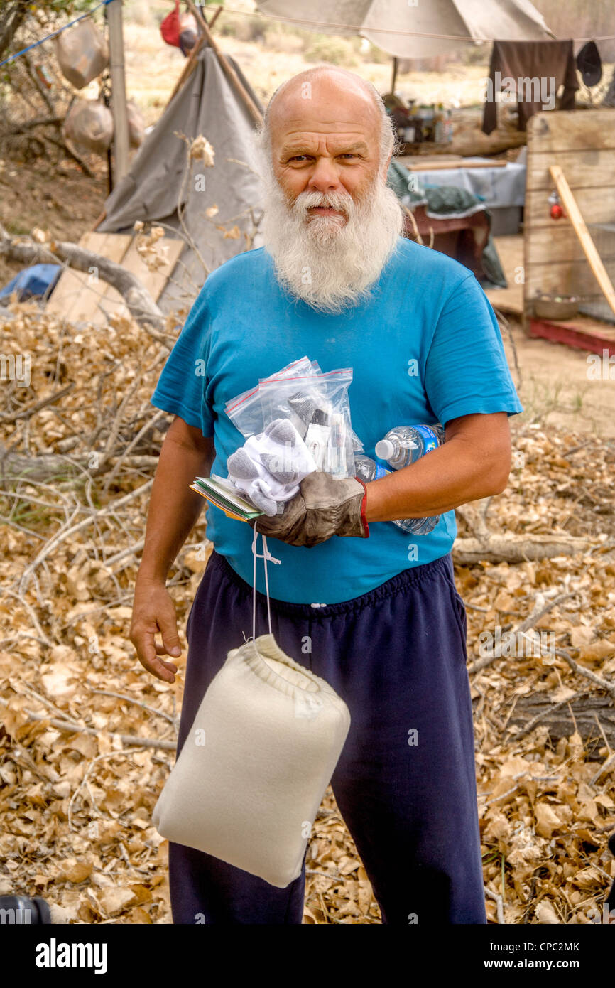 A homeless man holds toilet articles and a blanket donated by a local ...