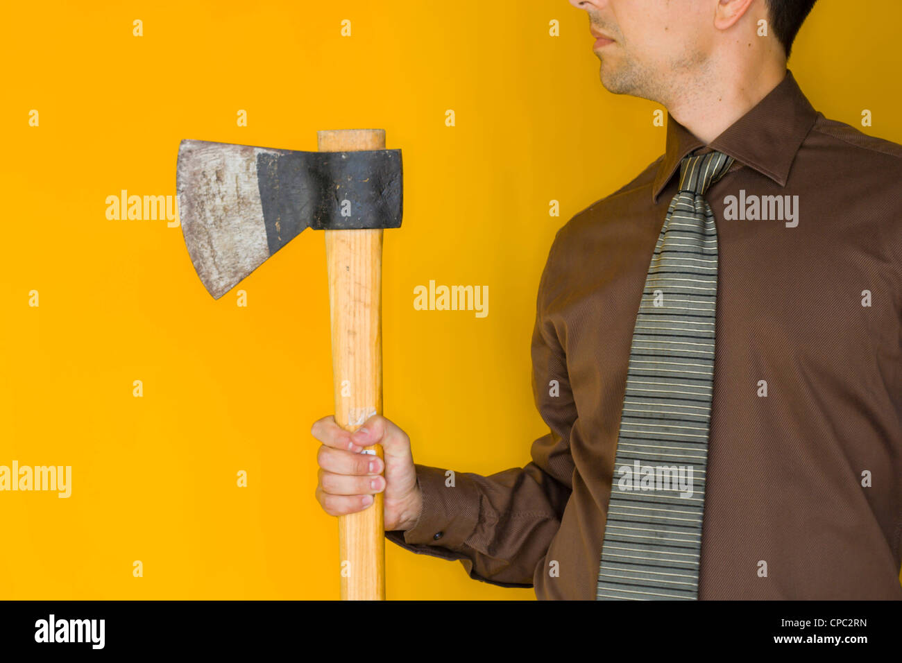 an anger bussiness man holding an axe Stock Photo - Alamy
