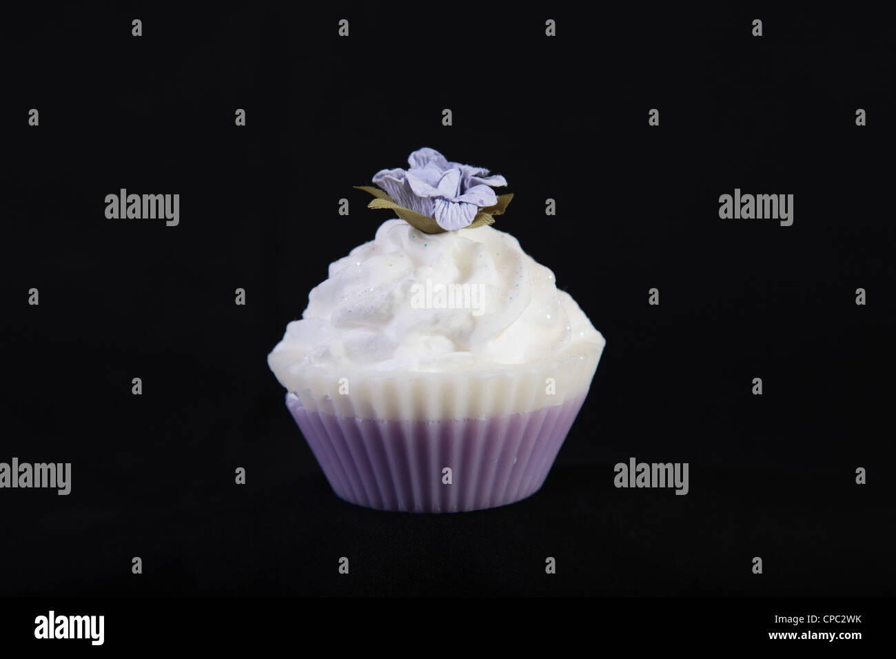 soap in the shape of a cupcake with blue flowers on top with black ...