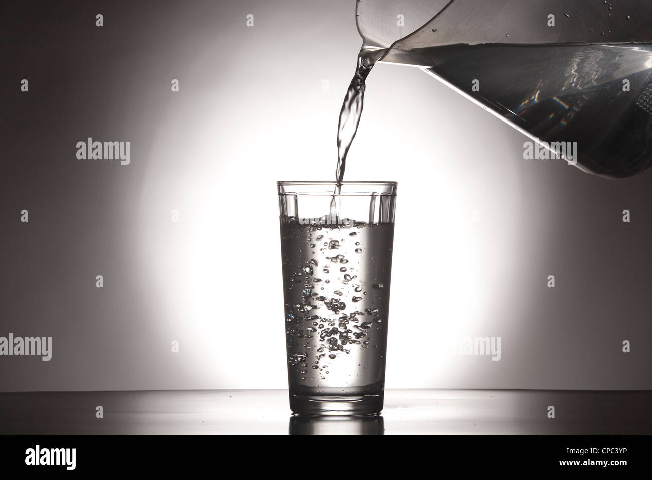 The act of pouring water into a glass Stock Photo - Alamy