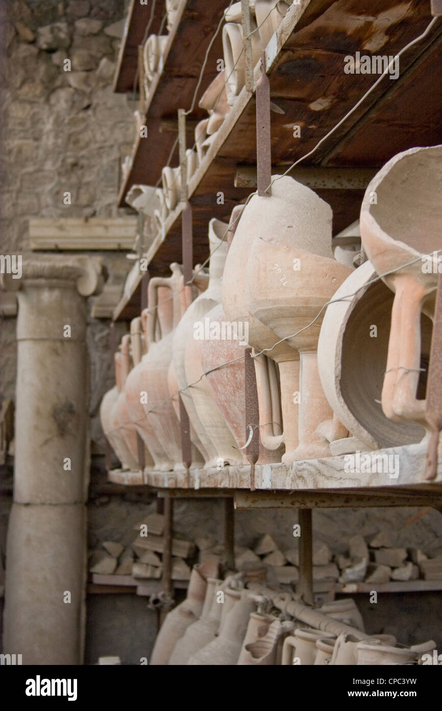 Ancient stone vases lined up on shelf Stock Photo - Alamy