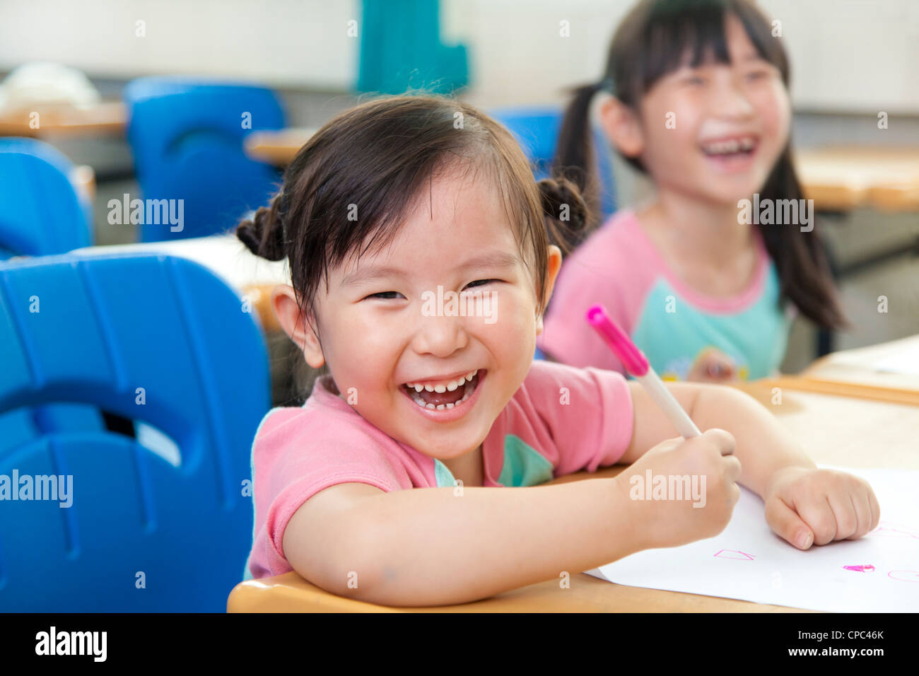 happy little girls in the classroom Stock Photo - Alamy