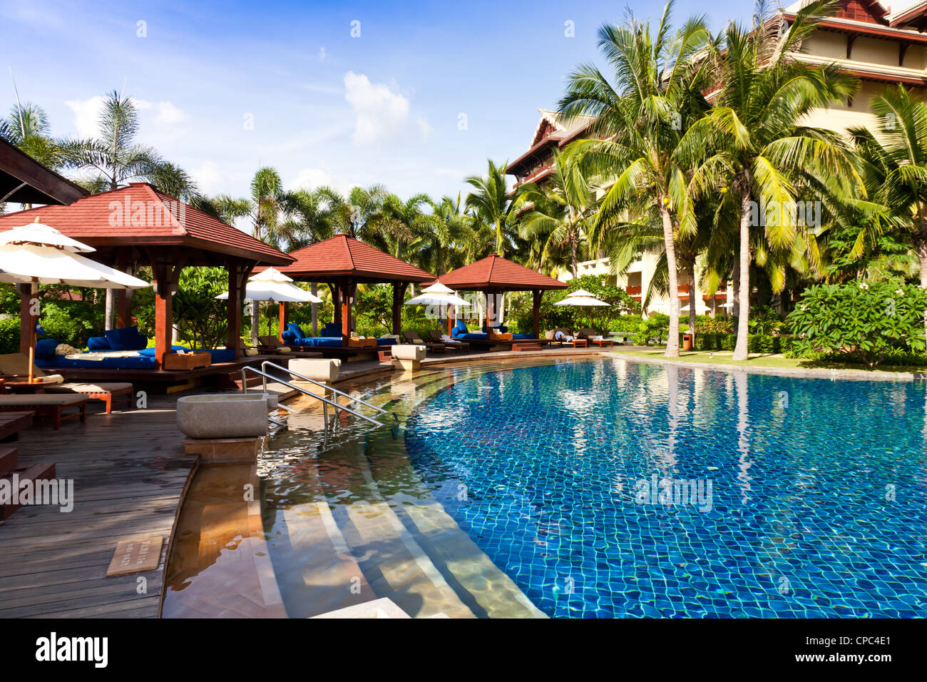 Resort swimming pool with sunshade and massage bed at poolside Stock ...