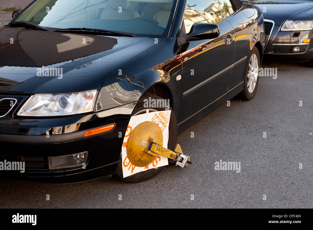 a wheel clamp on a parked car - USA Stock Photo - Alamy