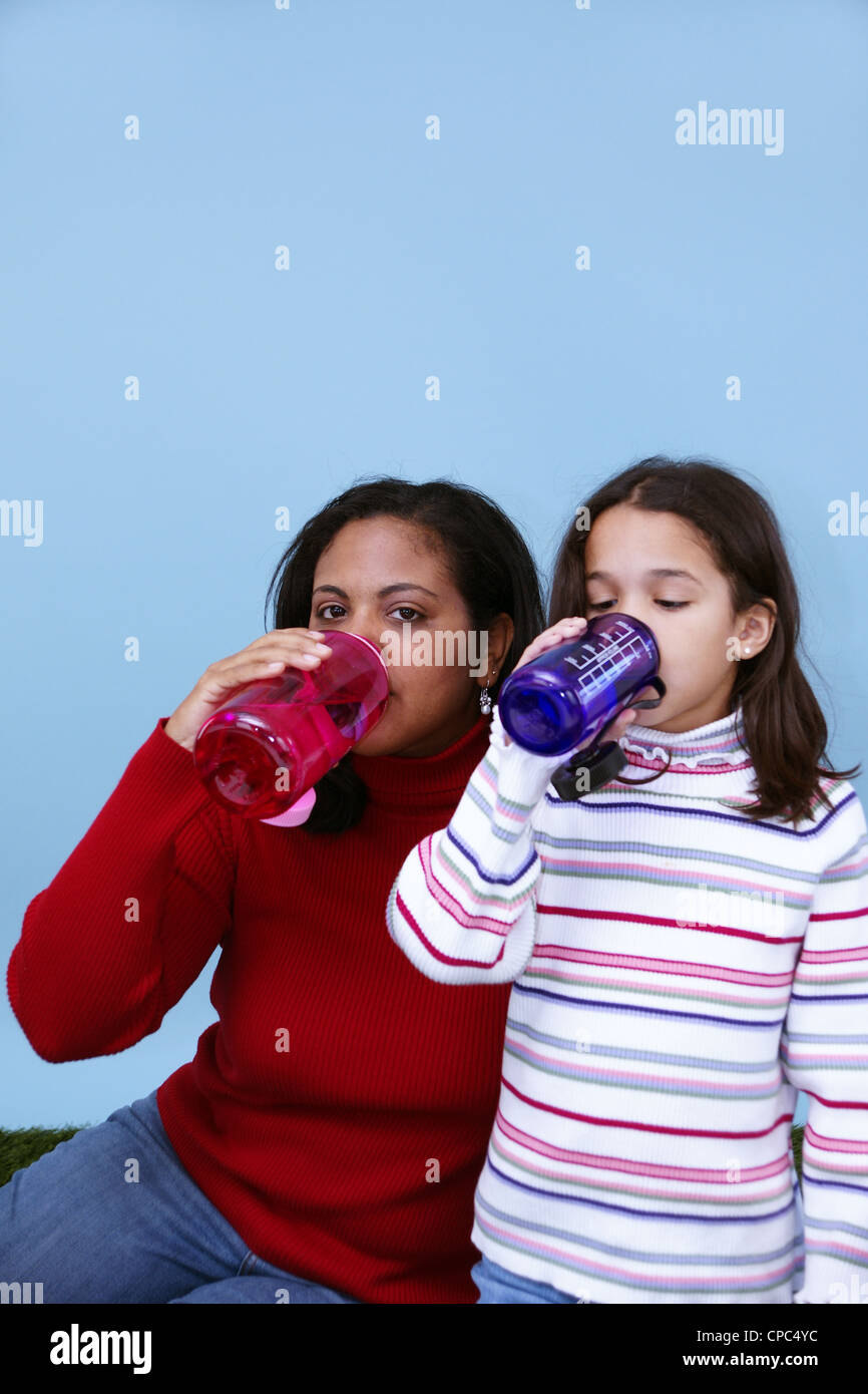 Family drinking from a bottle of water Stock Photo - Alamy