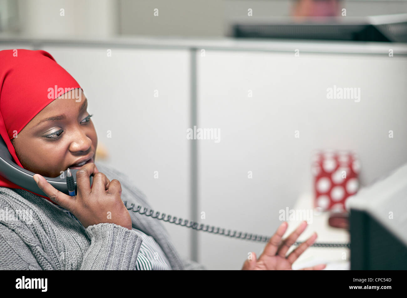 A woman working the phone lines in an office Stock Photo - Alamy