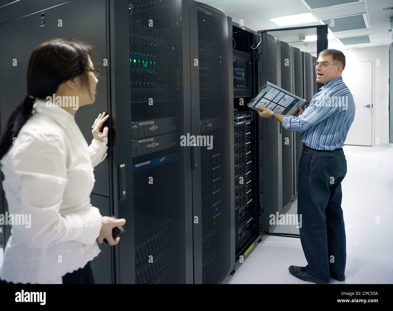 A woman talking technician who is maintaining the server room Stock ...