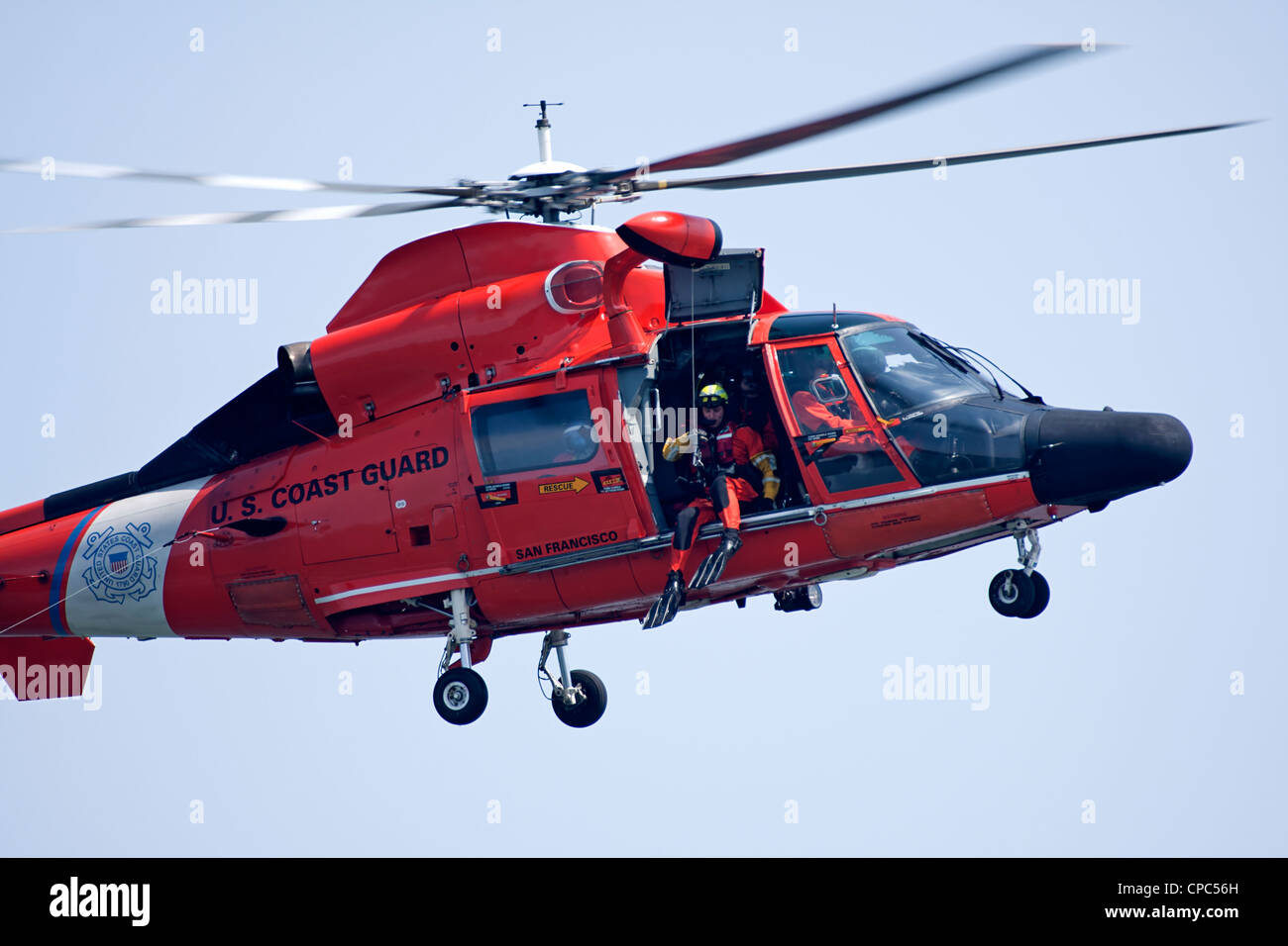 A swimmer prepares to be lowered to the water from a United States ...