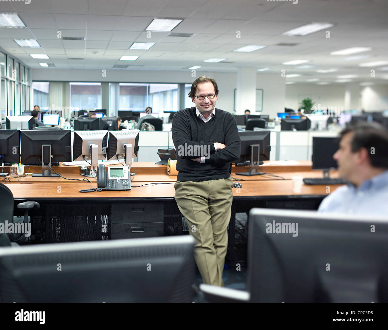 Traders having a discussion in an office Stock Photo - Alamy