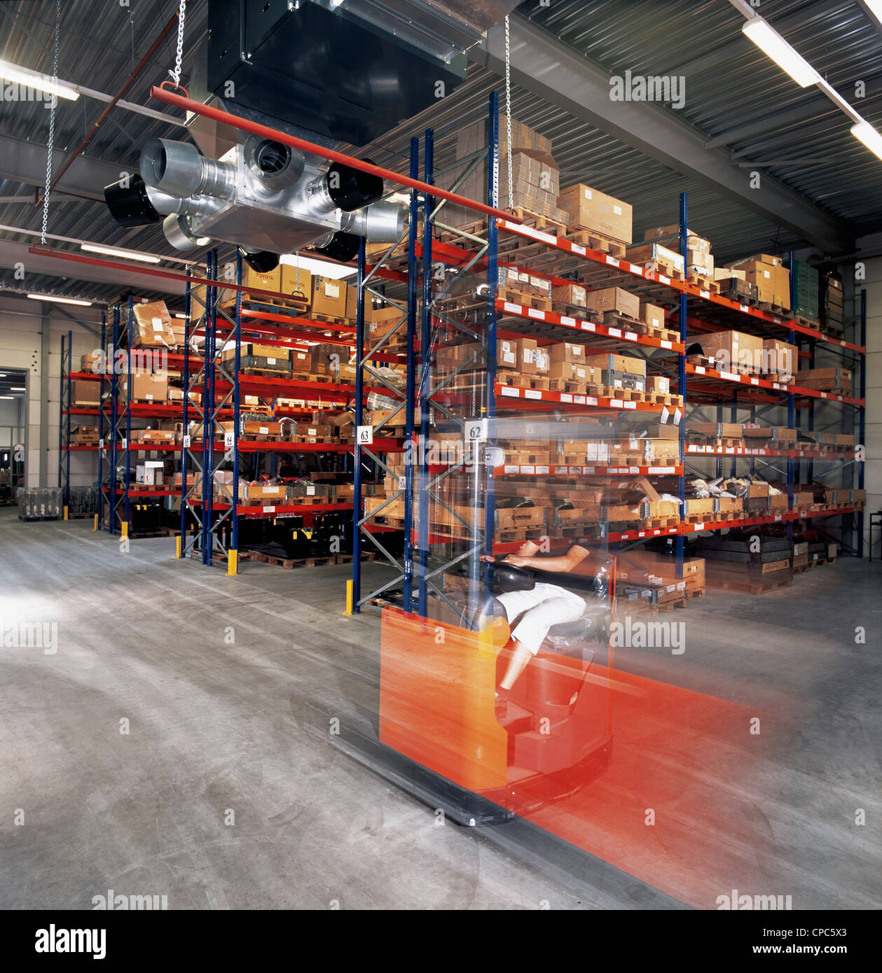 warehouse worker driver with forklift in warehouse Stock Photo - Alamy