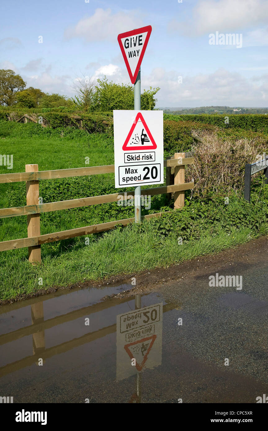 A warning road sign, maximum speed limit and stone chips Stock Photo ...