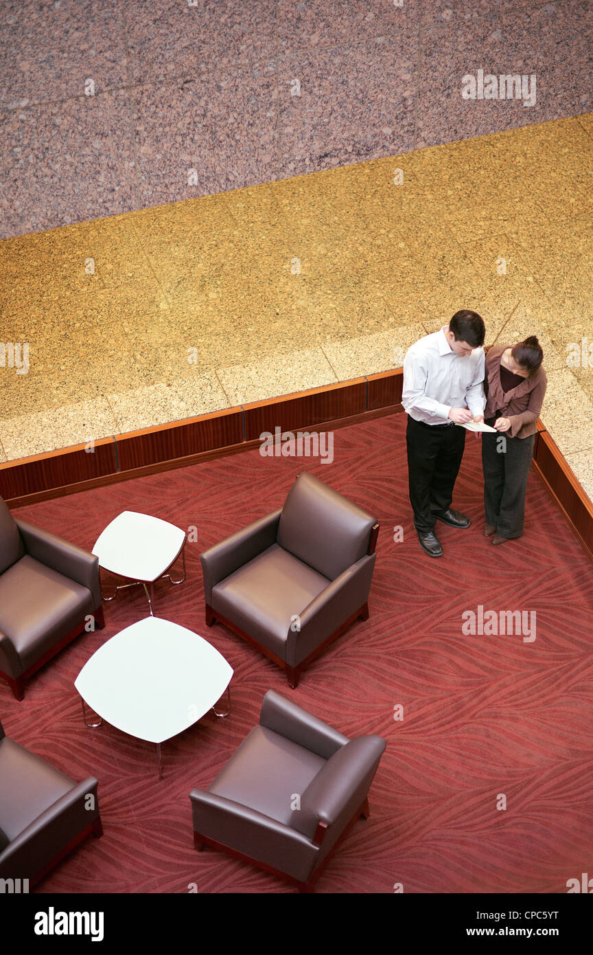 People chatting in the lobby of an office building Stock Photo - Alamy