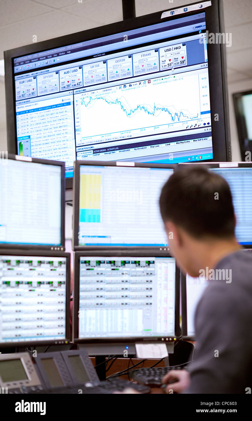 A man monitors multiple trade screens Stock Photo - Alamy