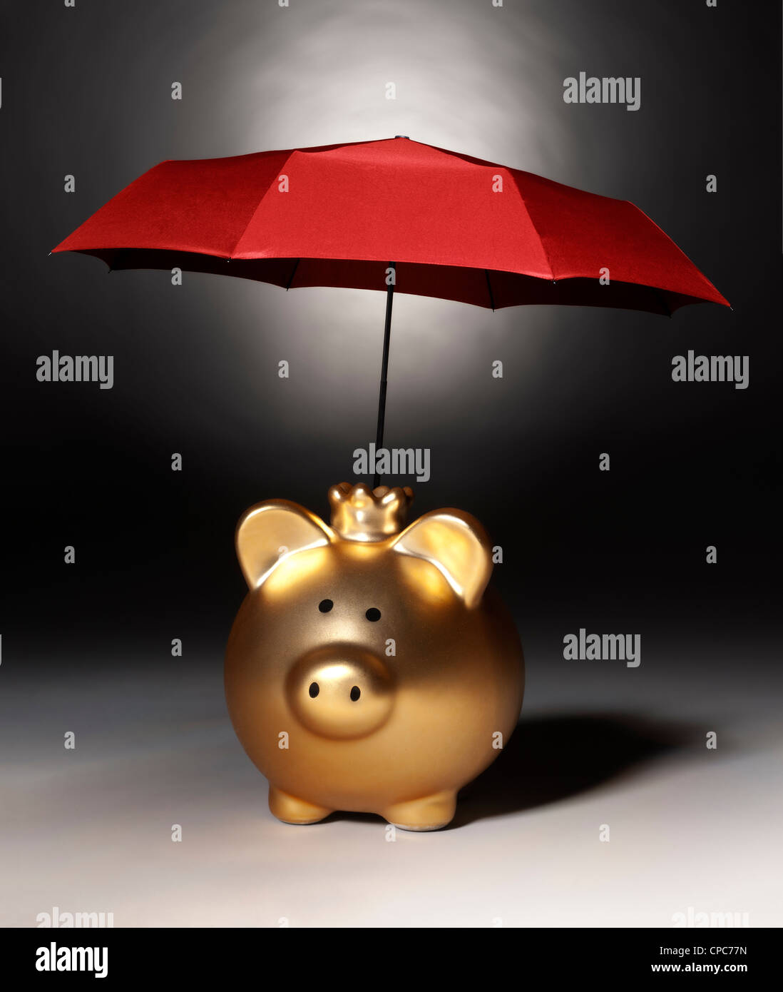 Golden piggy bank is protected by a red umbrella Stock Photo - Alamy Golden piggy bank is protected by a red umbrella Stock Photo - Alamy