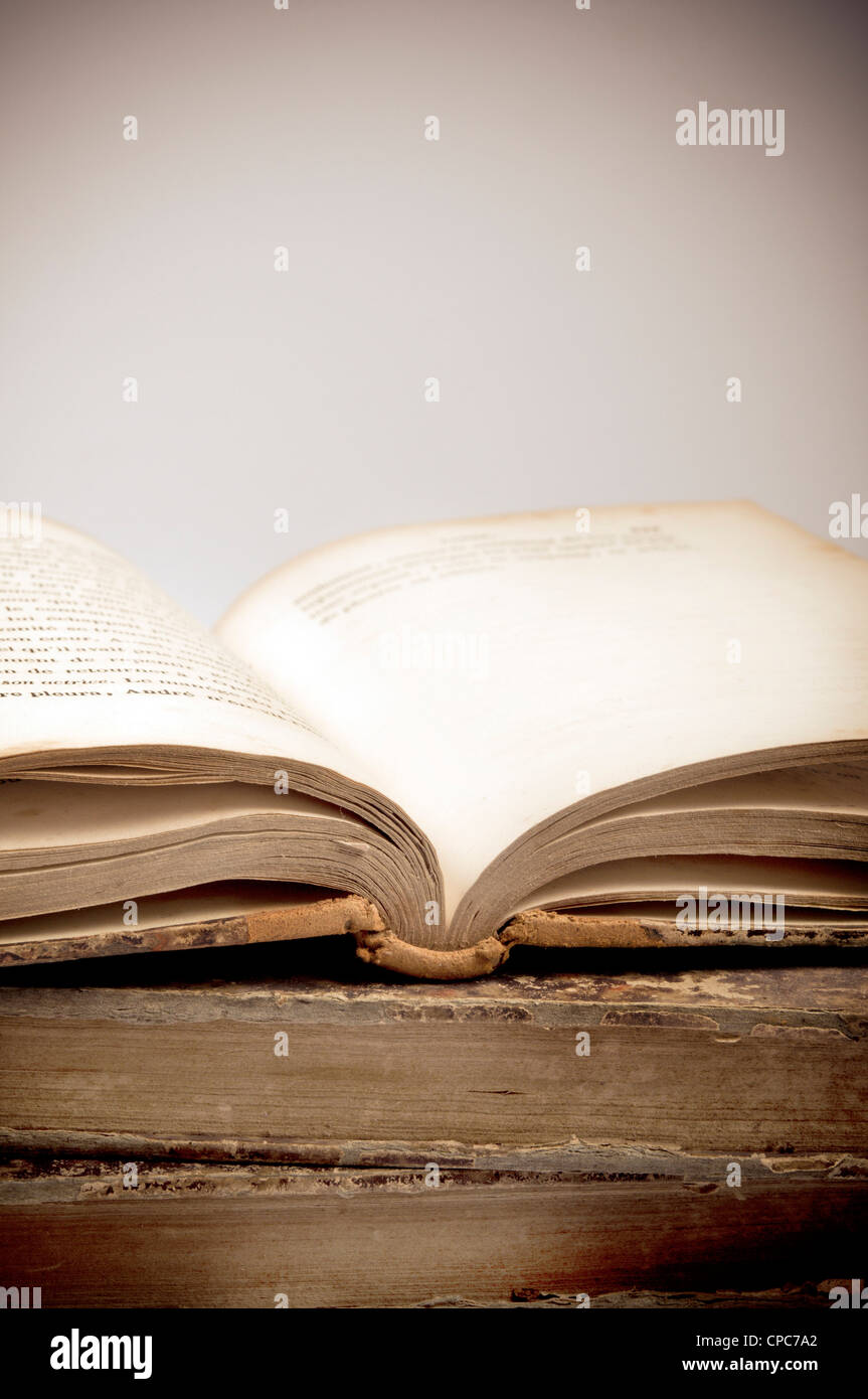 stack of old book, one opened on top Stock Photo - Alamy