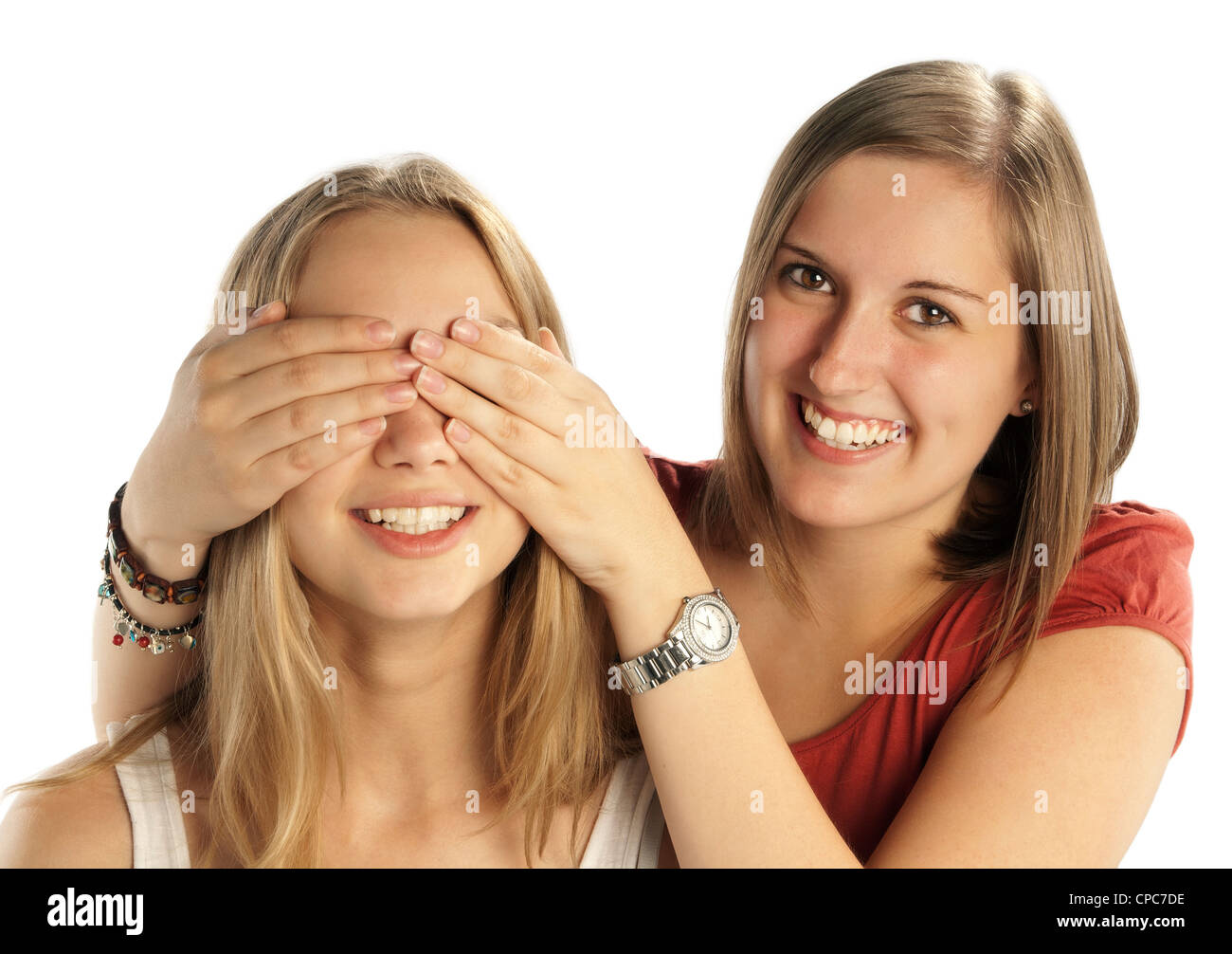 Young woman covers her friend's eyes with her hands Stock Photo - Alamy