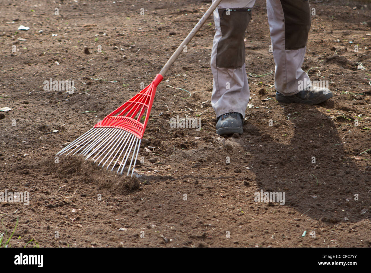 Raking dirt hi-res stock photography and images - Alamy