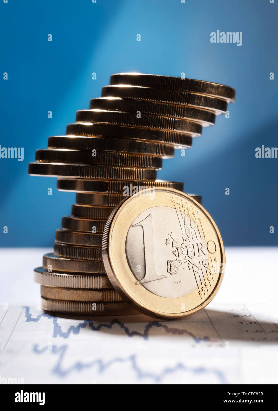 coin leaning on a wobbly pile of other coins Stock Photo - Alamy